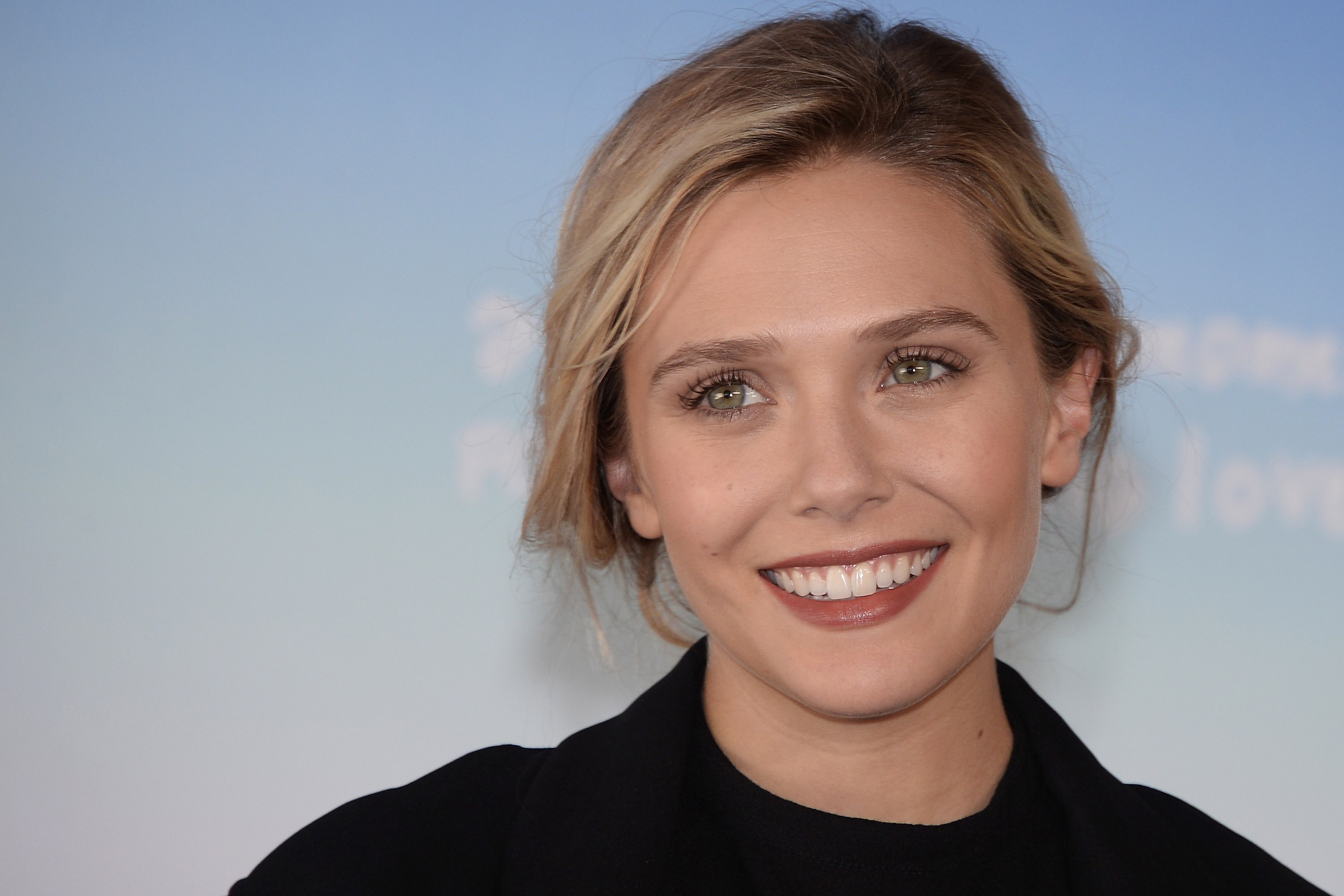 Elizabeth Olsen Close-Up: Blonde American Actress with Captivating Green Eyes Smile