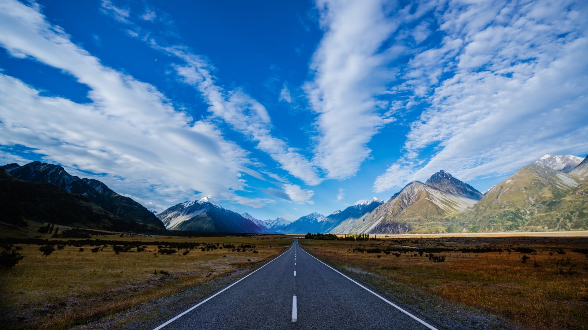 Endless Highway: Man-Made Road Through Majestic Mountains HD Wallpaper