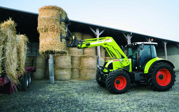 Claas Axion 990 Tractor: HD Wallpaper in a Dramatic Field Landscape