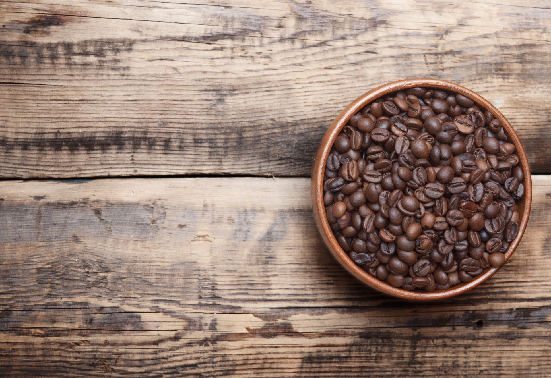 Rustic Aromas: 4K Ultra HD Coffee Beans on Weathered Wood Background