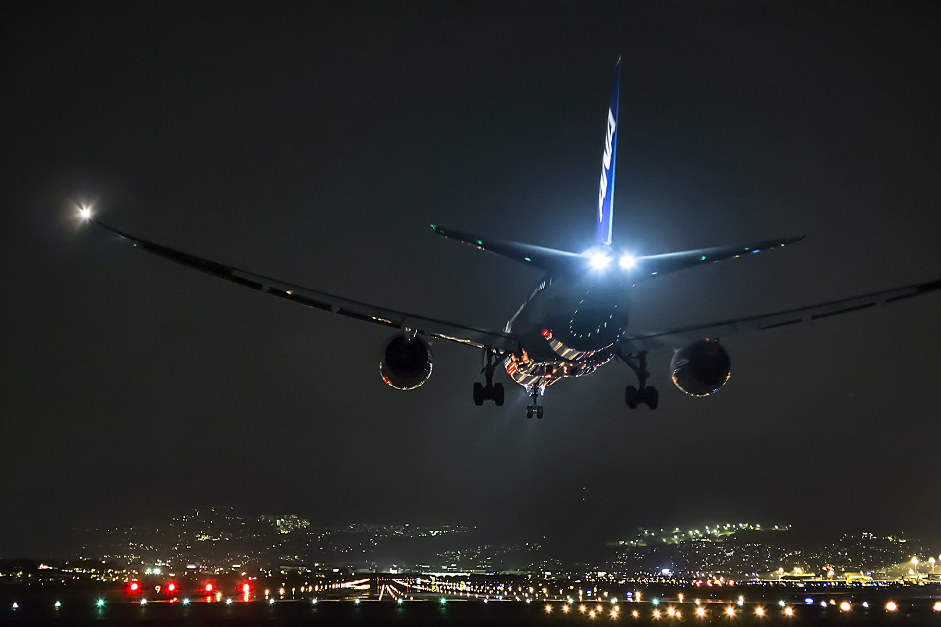 Nighttime Cityscape: HD Wallpaper of Aircraft in Flight