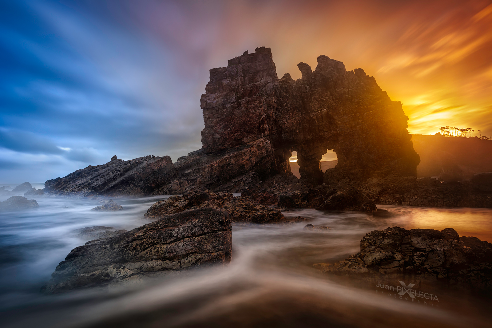 Sunset over Ocean Rocks by Juan PIXELECTA
